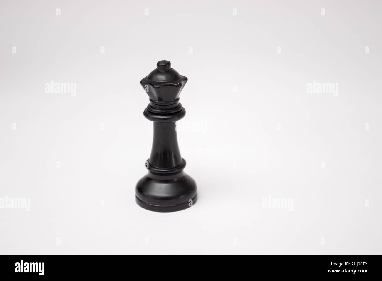 Black Chess piece queen on a white background Stock Photo - Alamy