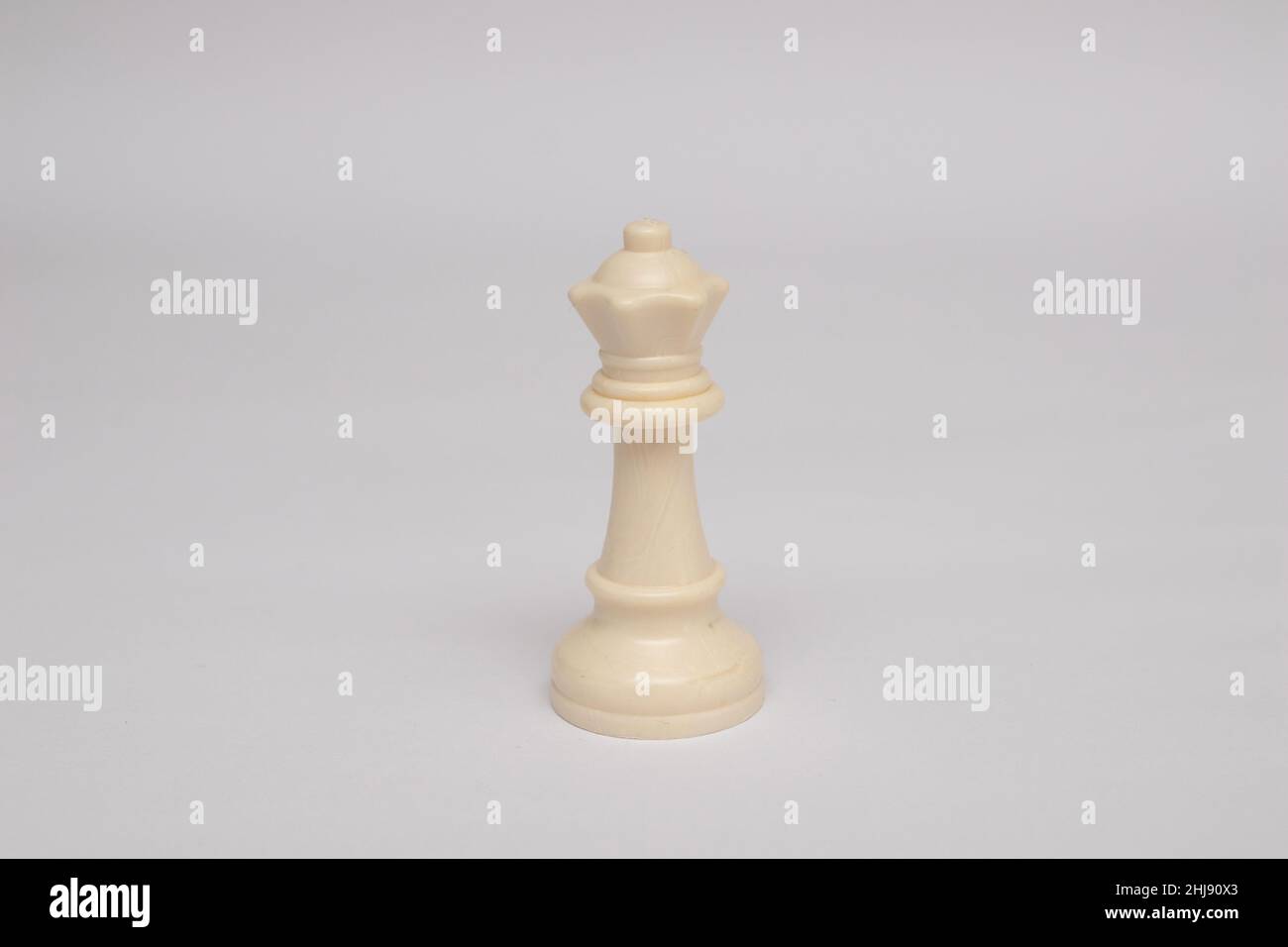 Chess piece queen on a white background Stock Photo - Alamy