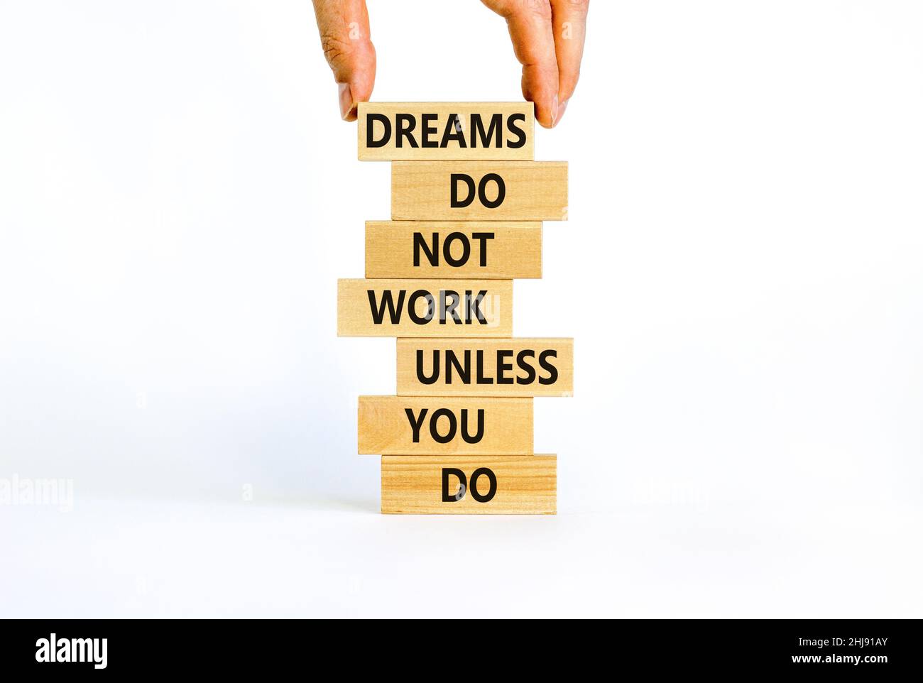 Dream and do symbol. Wooden blocks with words Dream do not work unless ...