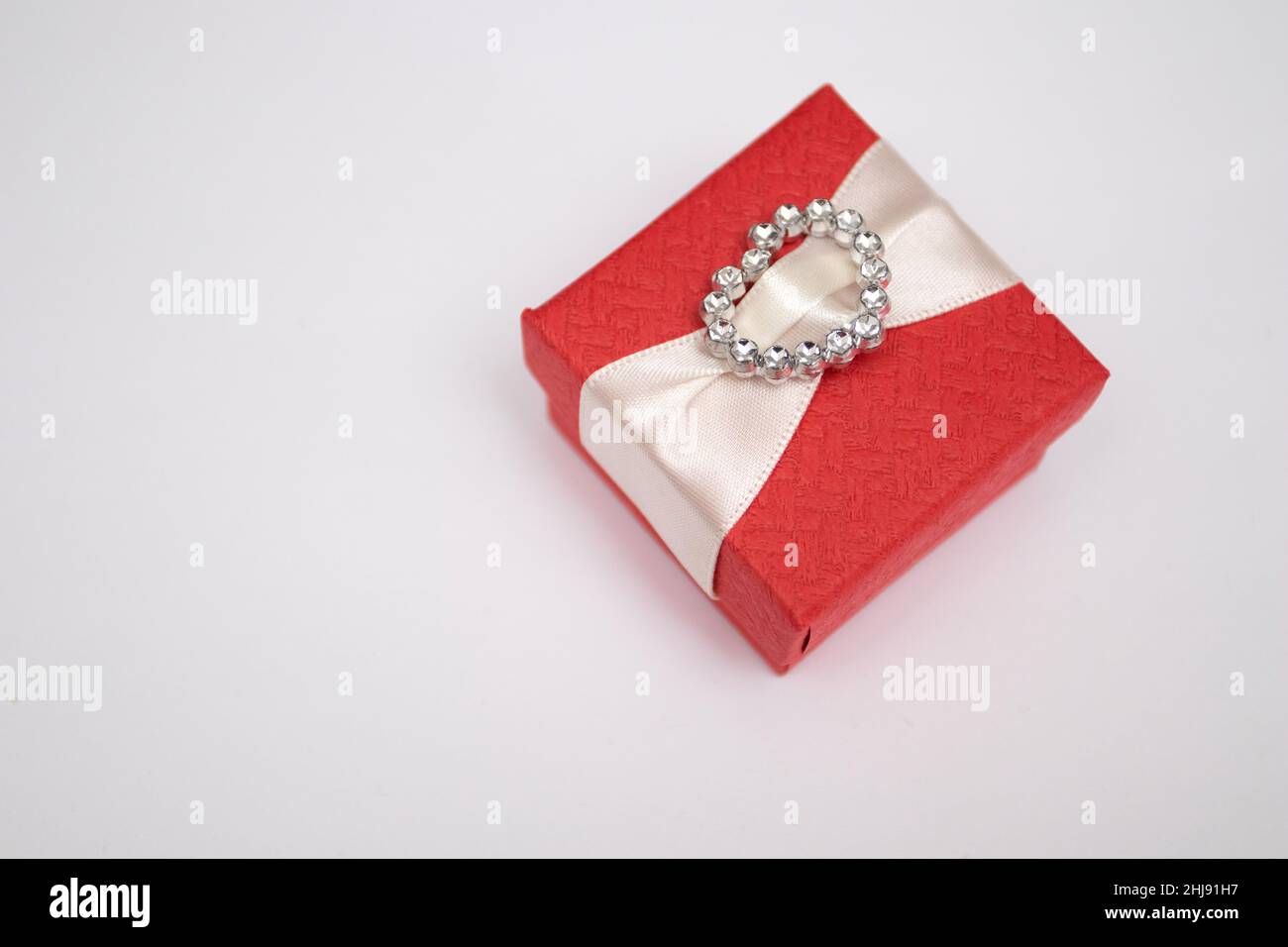 Red gift box on white background Stock Photo - Alamy