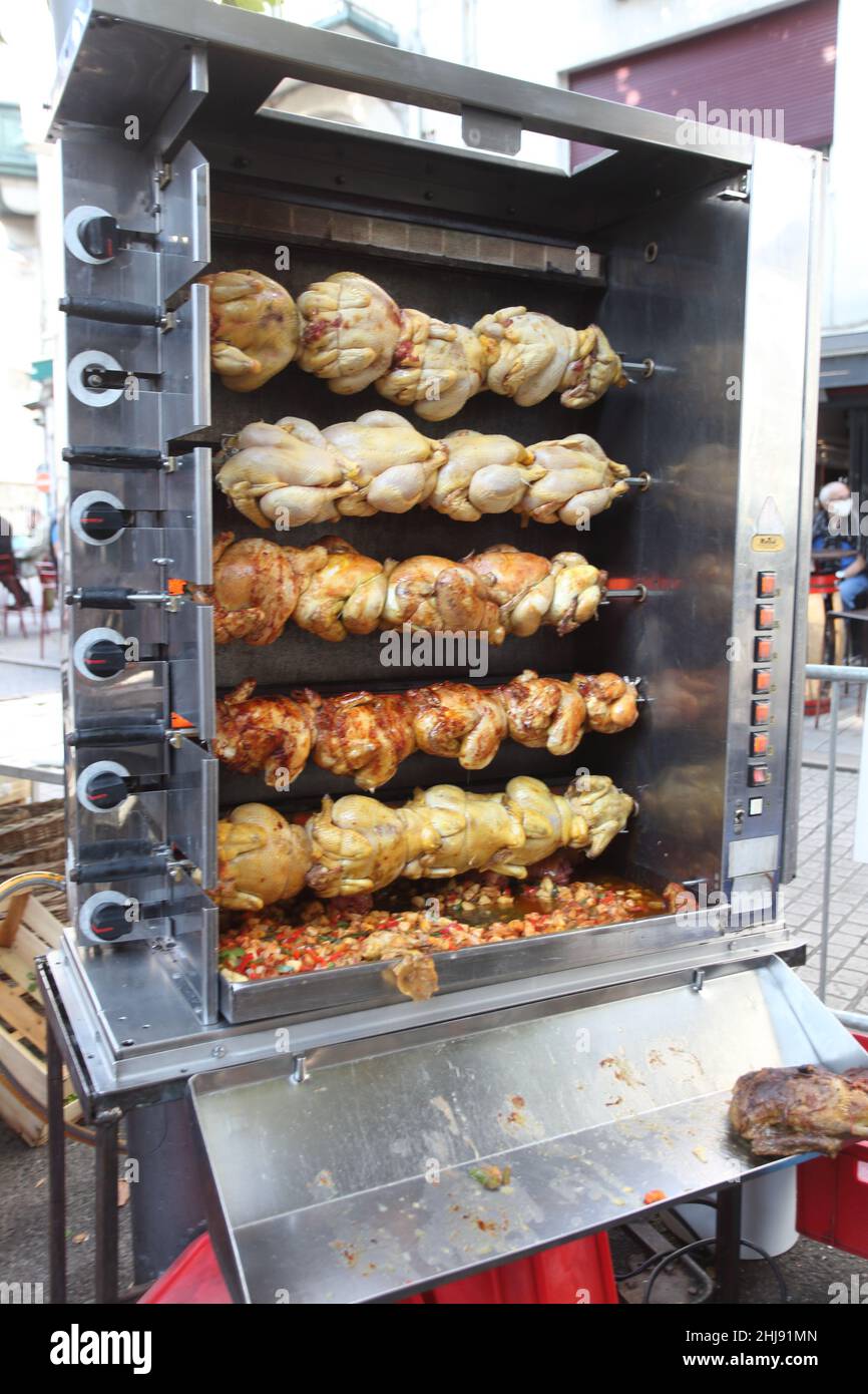 Typical french rotisserie spit roasting chickens at lunchtime in St ...