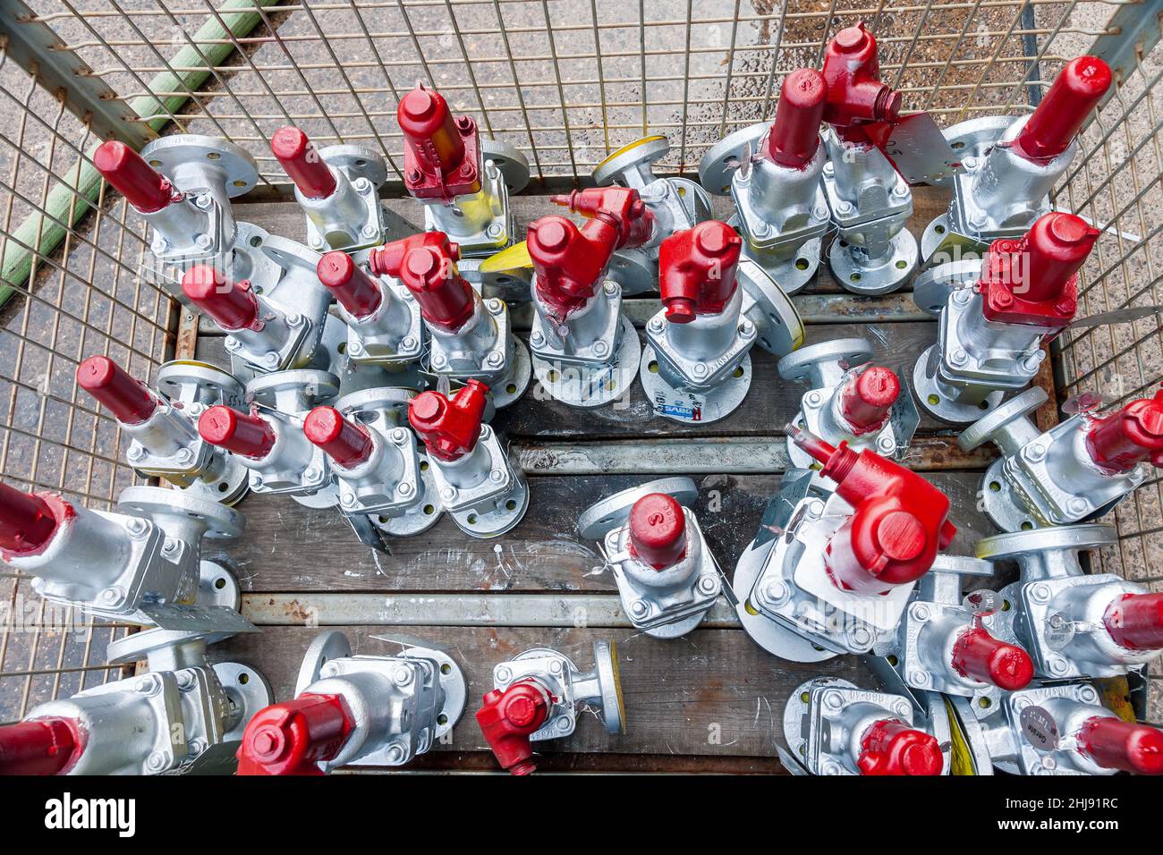 Safety relief valves in a mesh transport box, seen from above Stock ...