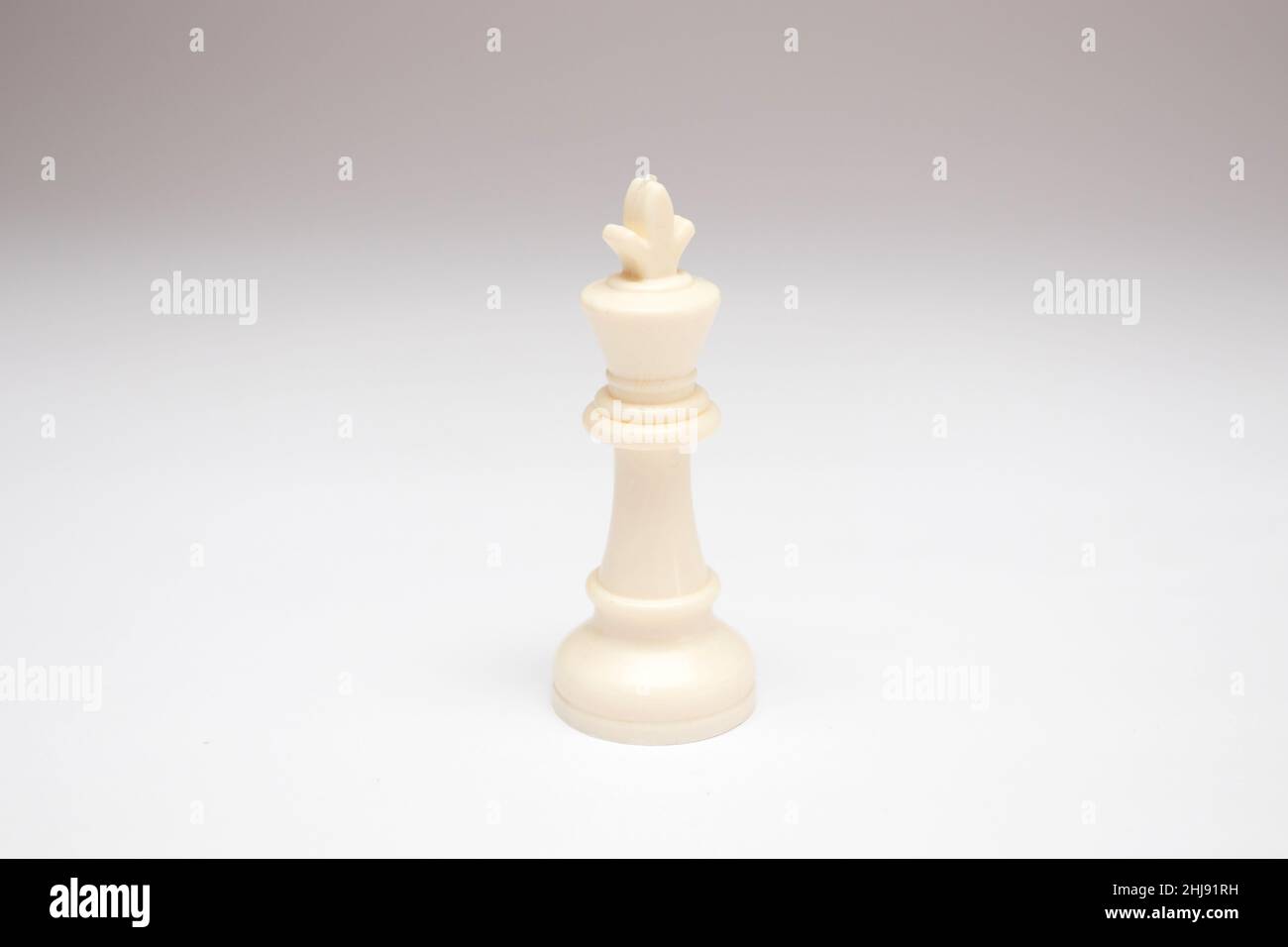 white King chess piece on white background Stock Photo - Alamy