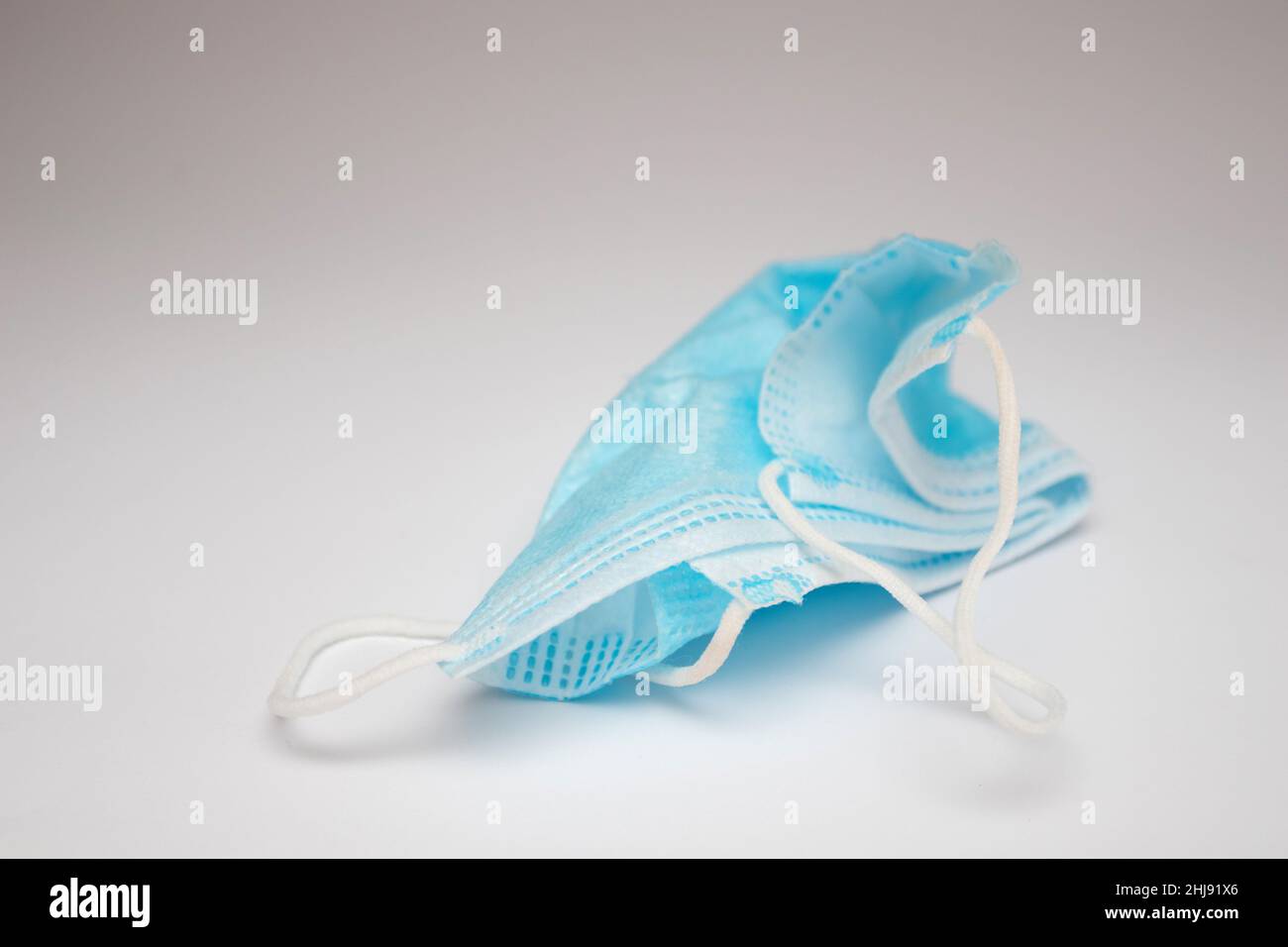 Crumpled medical disposable mask on white background Stock Photo - Alamy