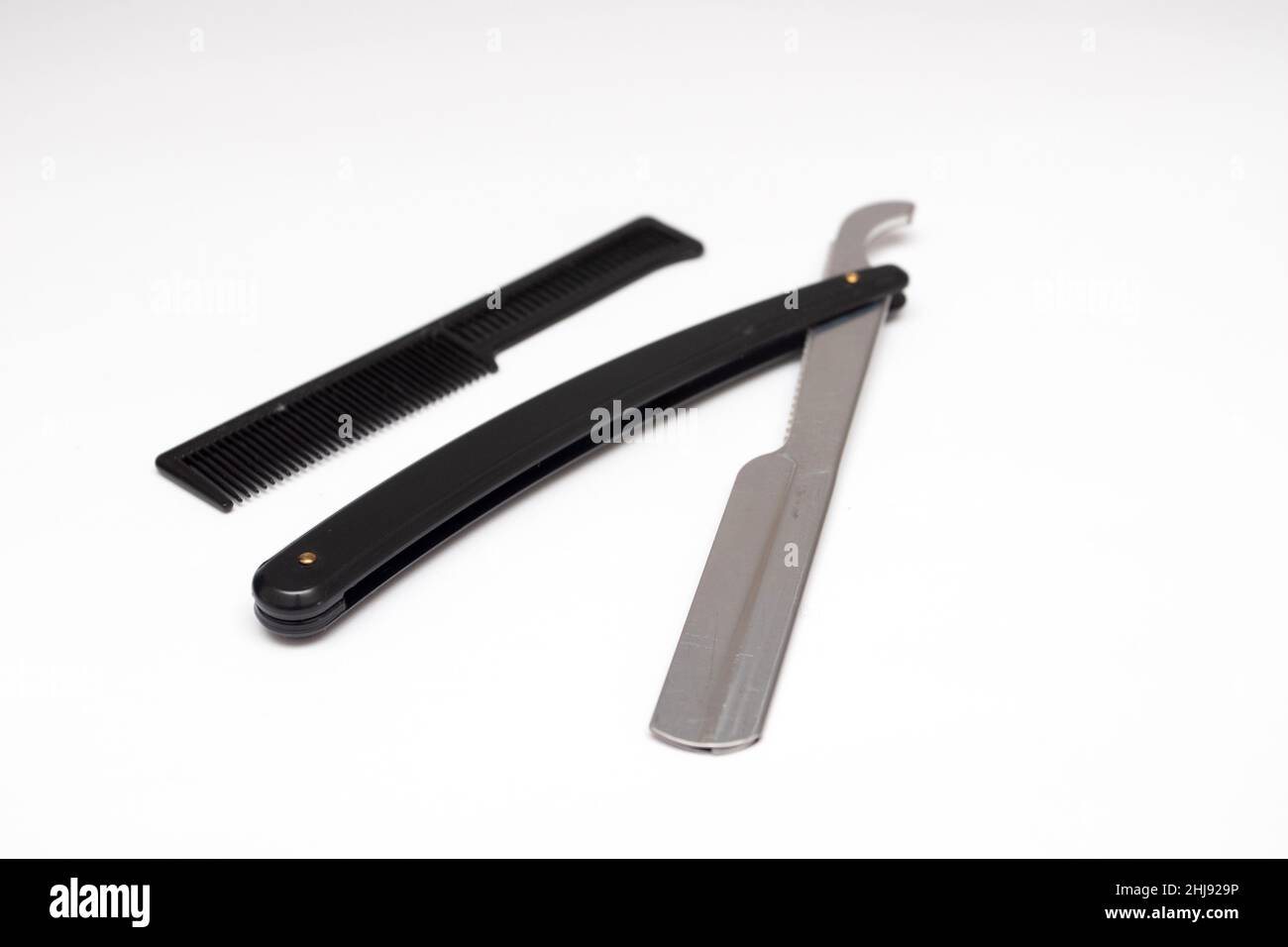 Black straight razor on a white background Stock Photo - Alamy