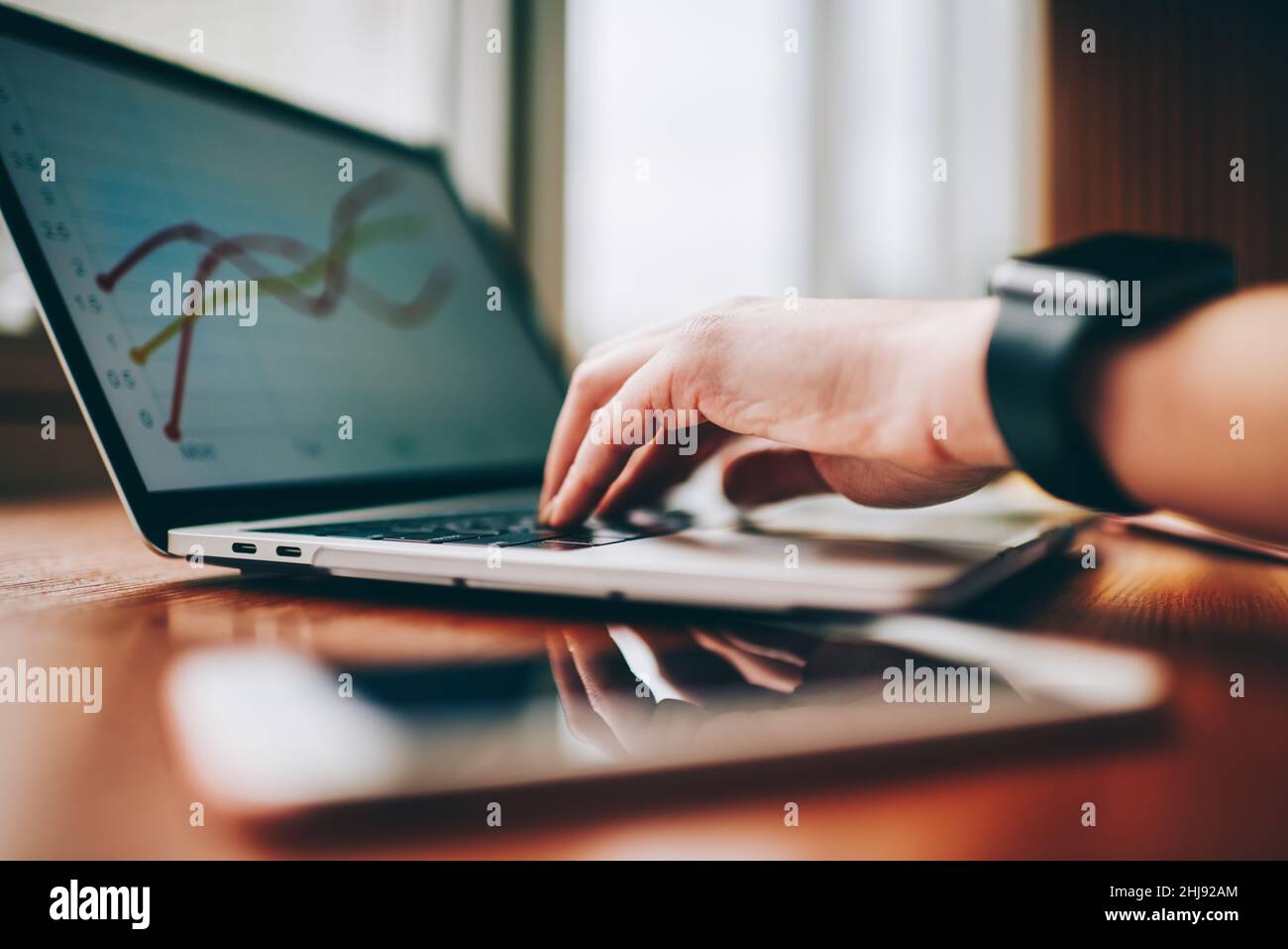 Faceless man typing on laptop and making graphs Stock Photo - Alamy