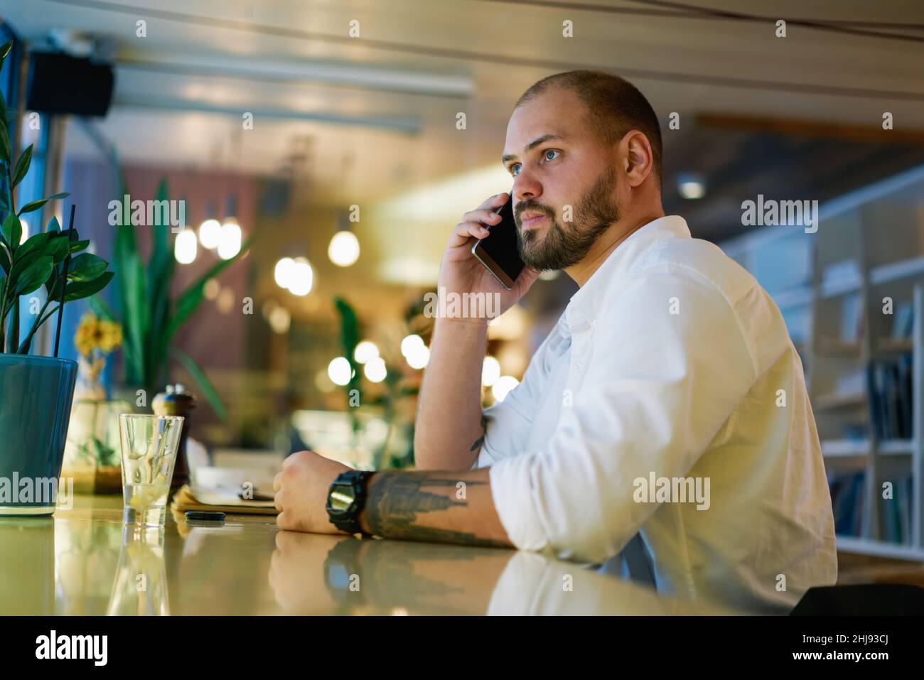 Focused man having conversation on smartphone Stock Photo - Alamy