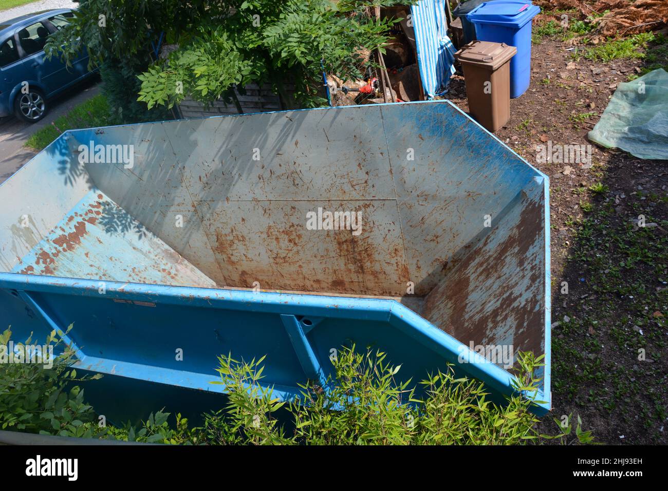 A large empty waste container stands in a driveway Stock Photo - Alamy