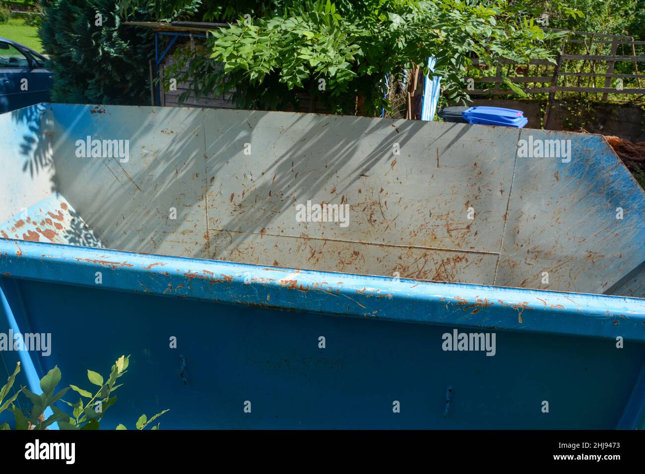 One large empty waste container in a courtyard Stock Photo - Alamy