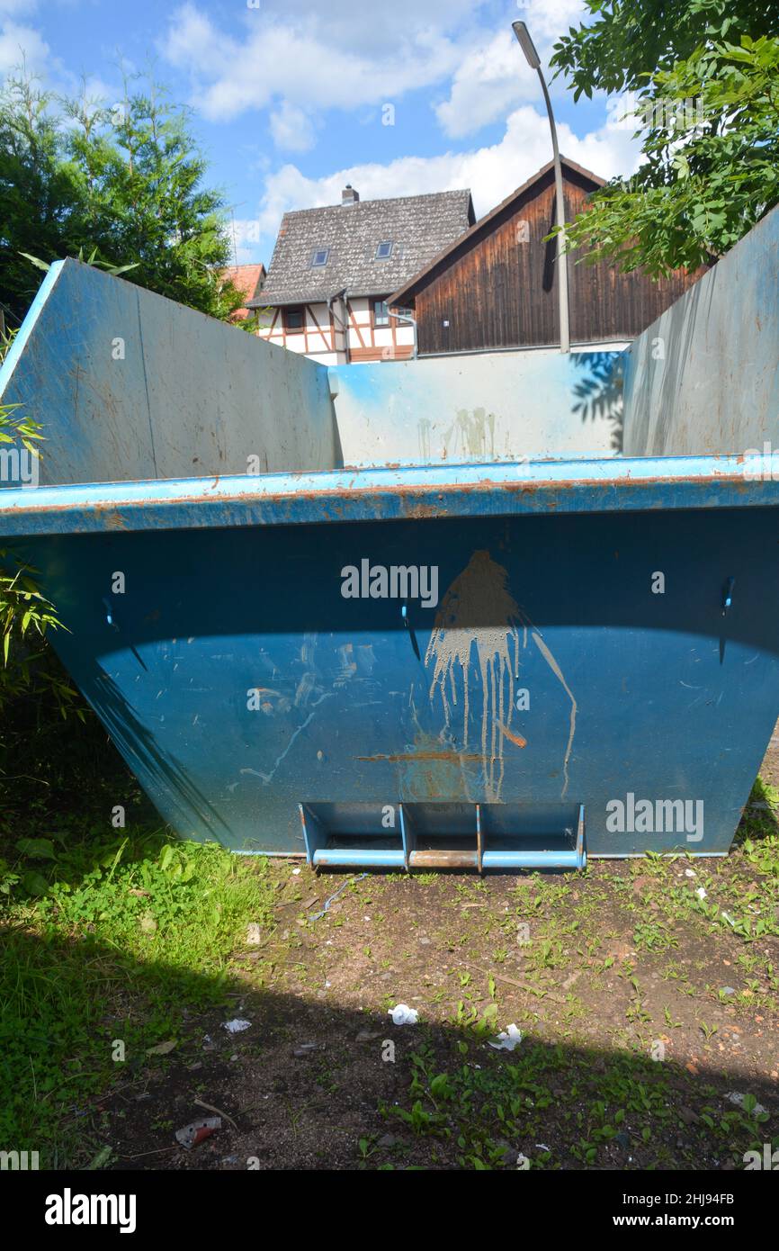 A large empty waste container stands in a driveway Stock Photo - Alamy
