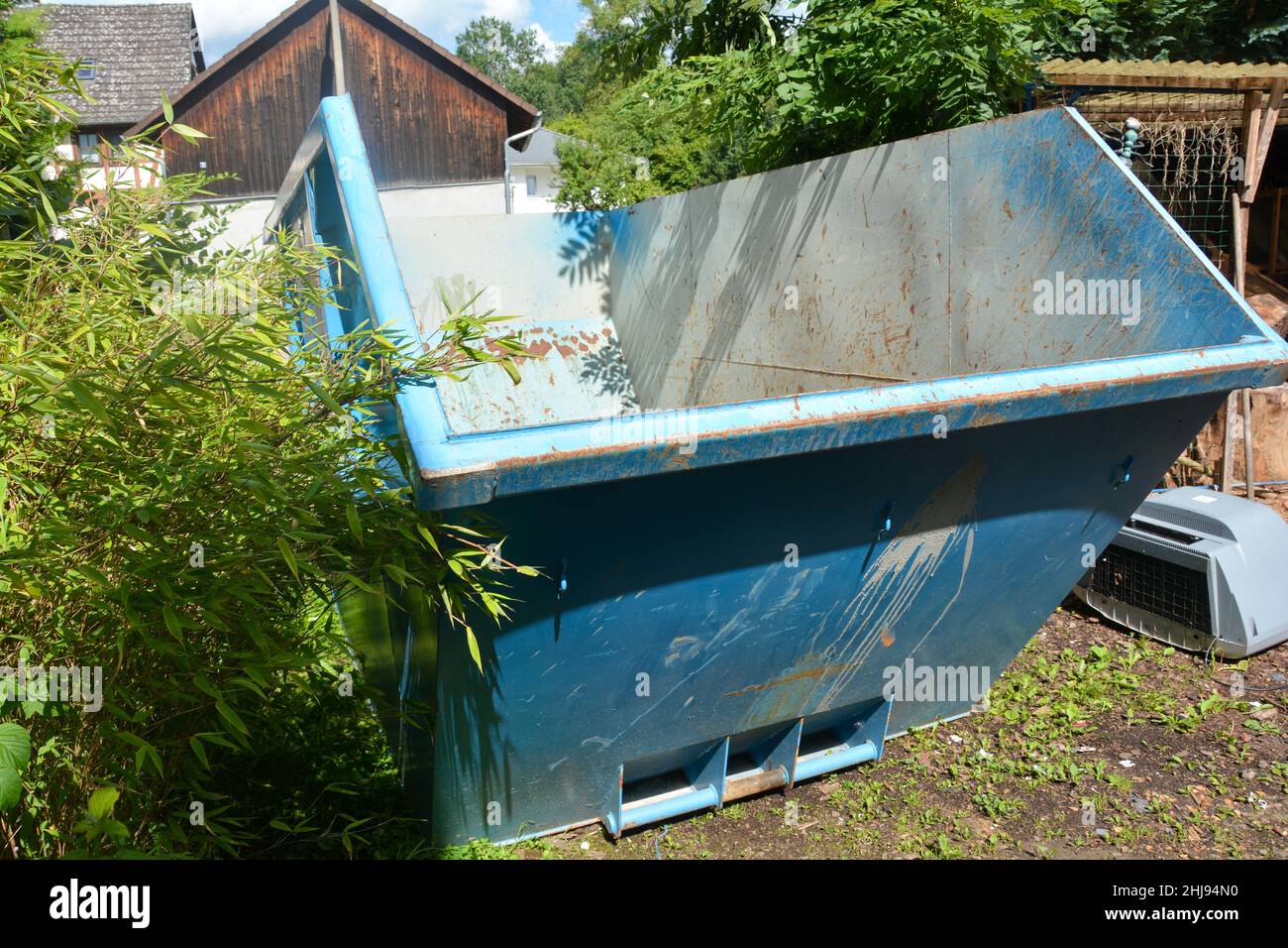 A large empty waste container stands in a driveway Stock Photo - Alamy