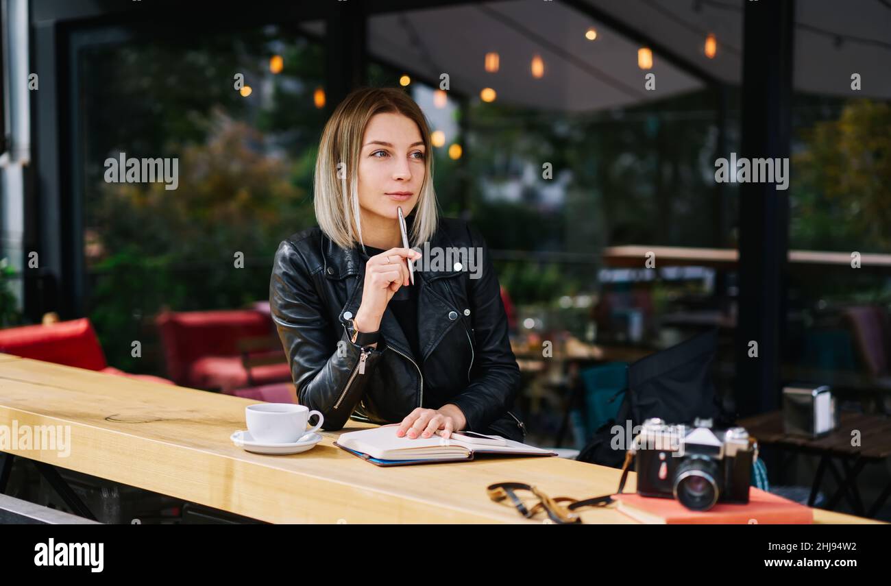 Serious woman looking at camera at desk with coffee cup hi-res stock ...