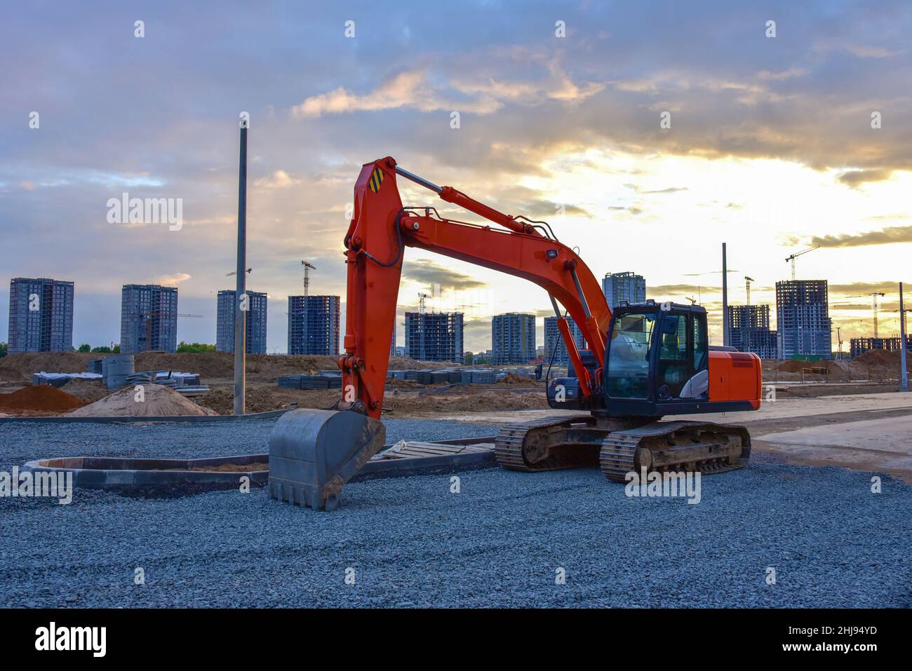 Excavator Working On Road Construction. Backfilling of gravel for ...