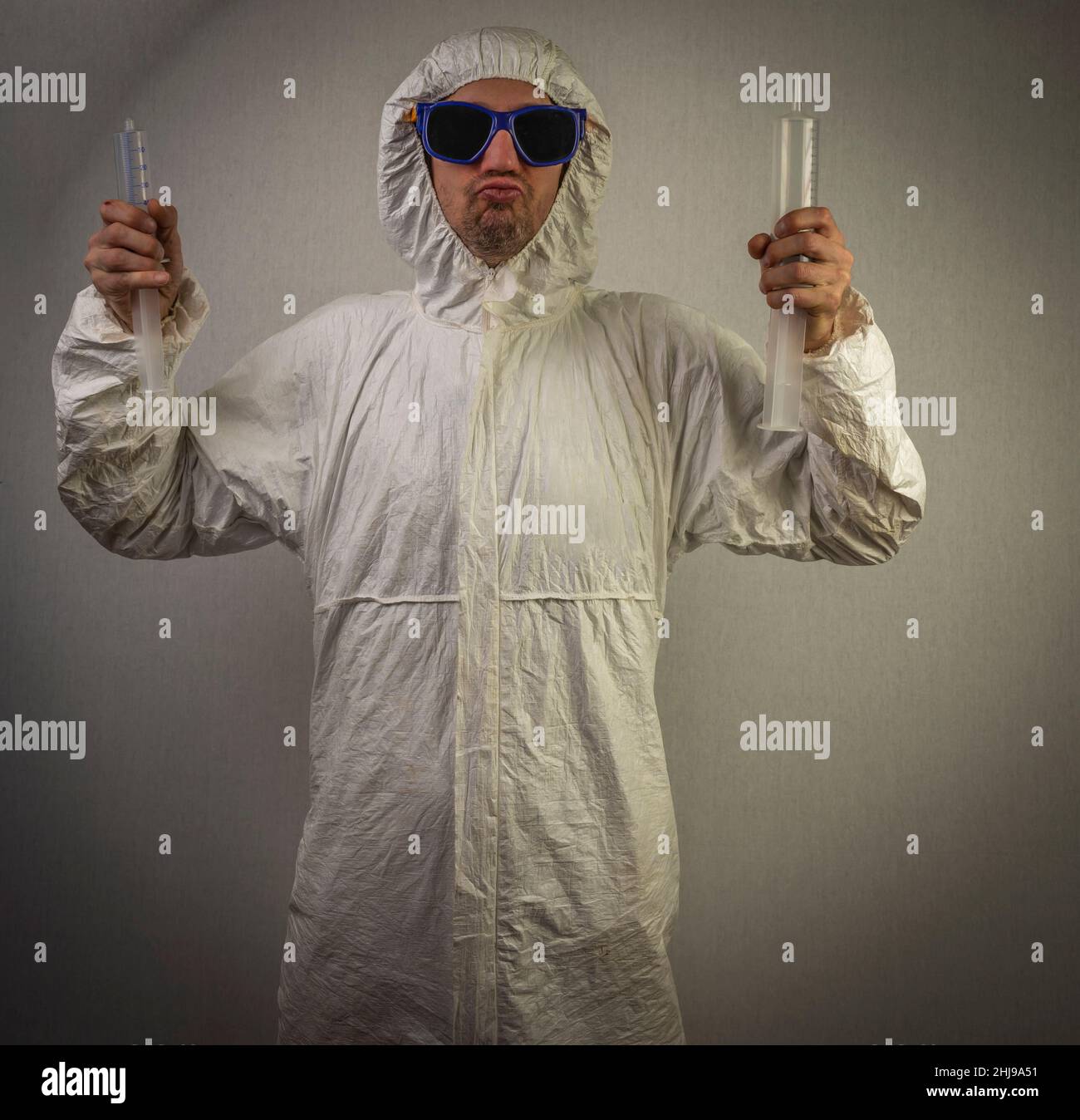 Man with white protection suit and big shot injection with white gray ...