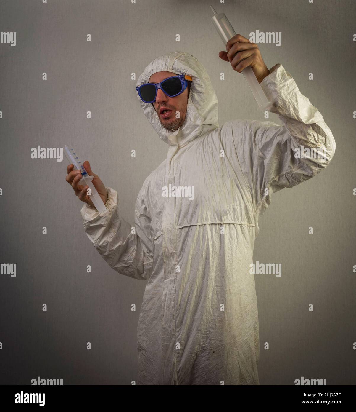 Man with white protection suit and big shot injection with white gray ...