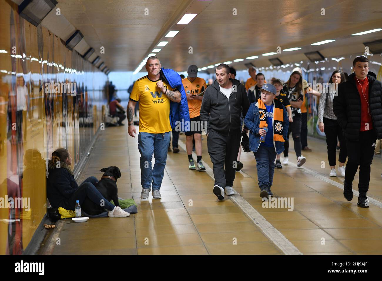 Wolves football supporters walking through subway passed a beggar with ...