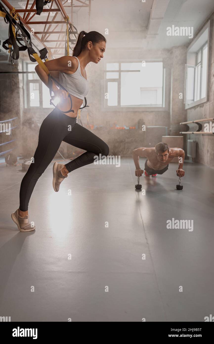 Attractive young woman getting fit at gym Stock Photo - Alamy