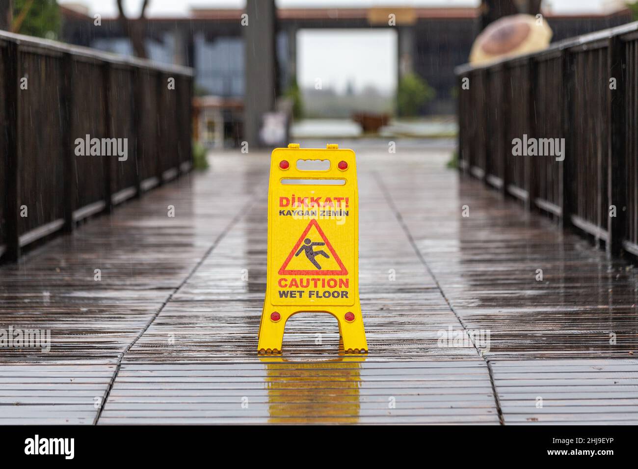 Yellow caution slippery floor sign Stock Photo - Alamy