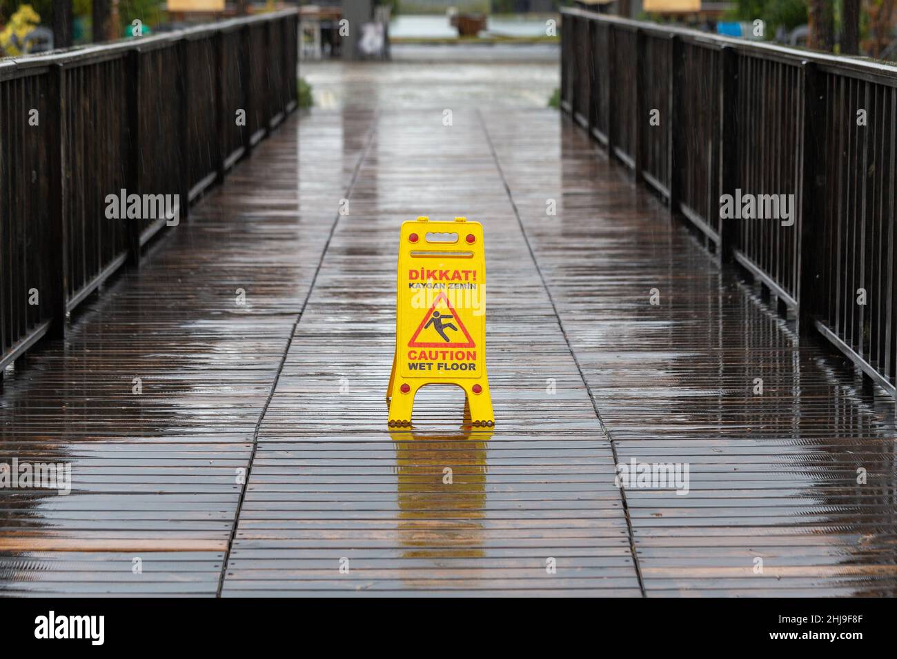 Yellow caution slippery floor sign Stock Photo - Alamy