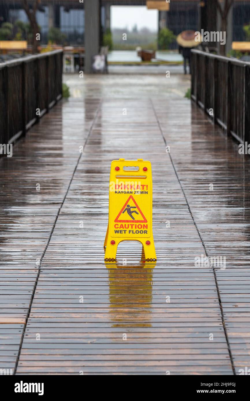 Yellow caution slippery floor sign Stock Photo - Alamy
