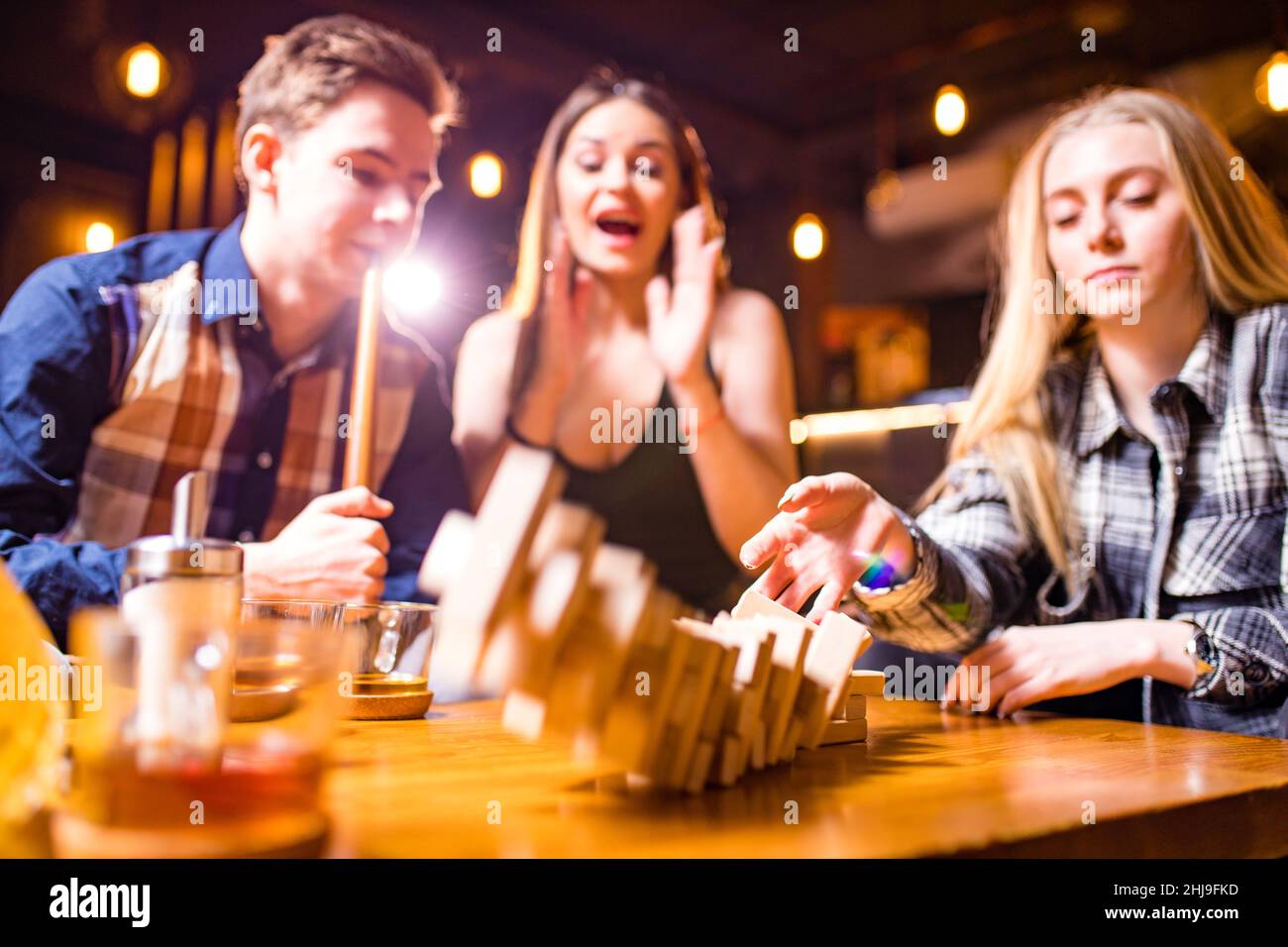 Young people have fun playing board games at a table Stock Photo - Alamy
