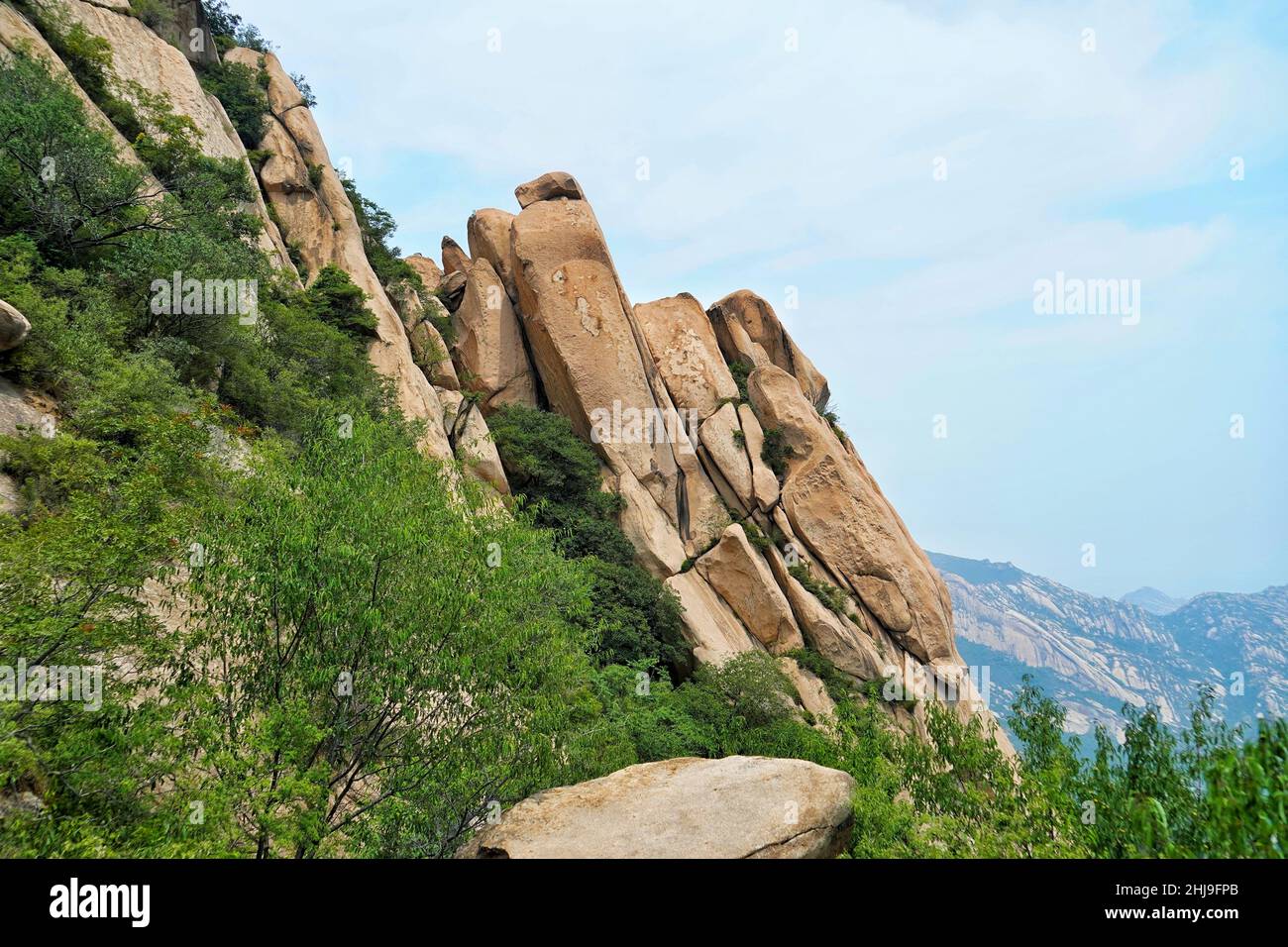 Natural landscape of cliffs with trees and bushes in China Stock Photo ...