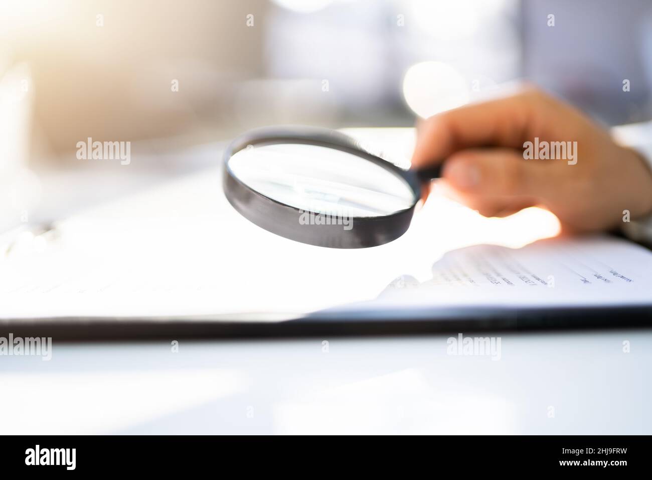 Investigator looking through magnifying glass hi-res stock photography ...