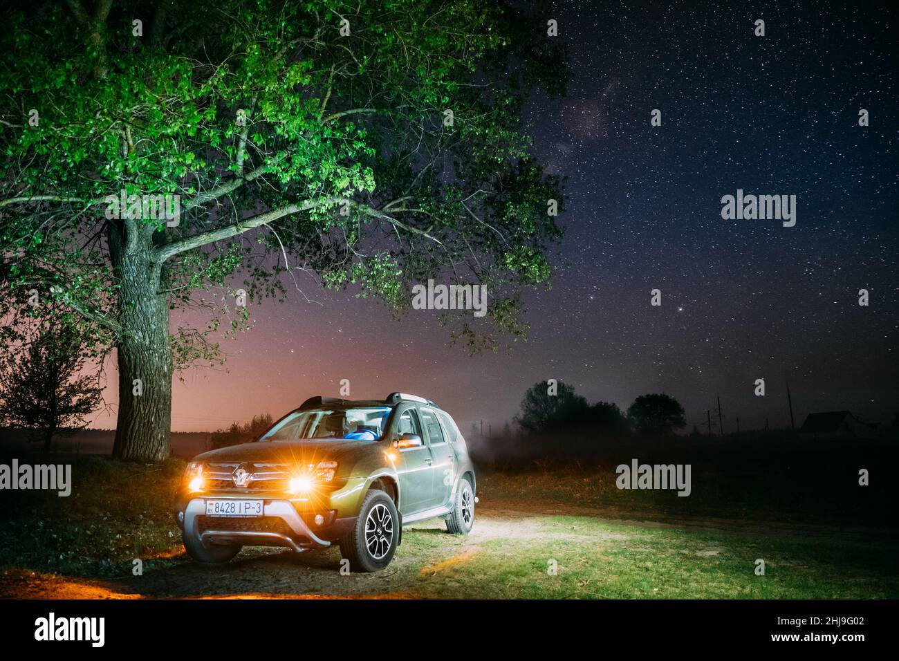 Night Starry Sky Above Car Renault Duster. SUV parked near lonely tree ...