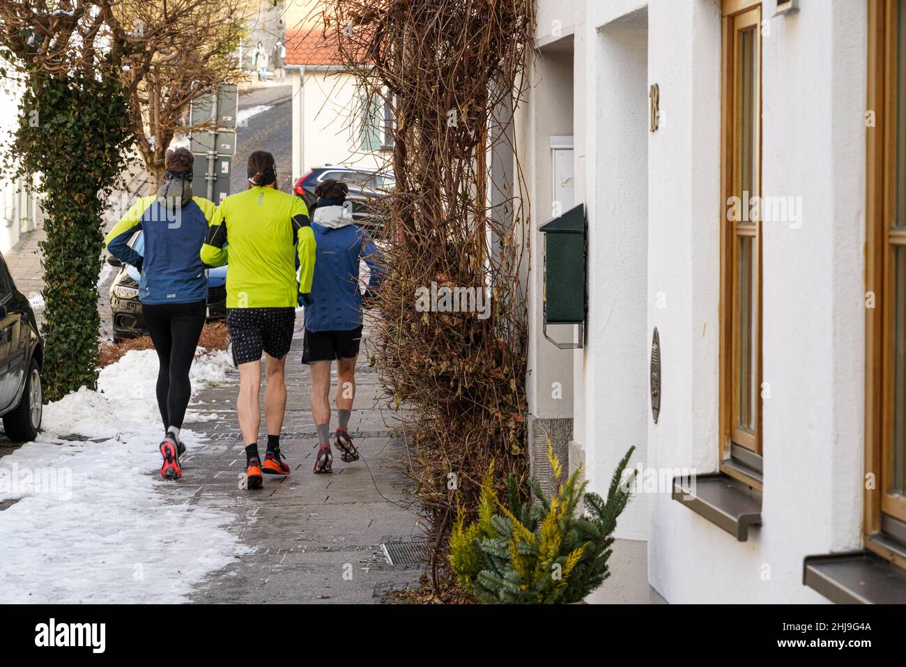 Three guys jogging in winter on a Pedestrian walkway Stock Photo - Alamy