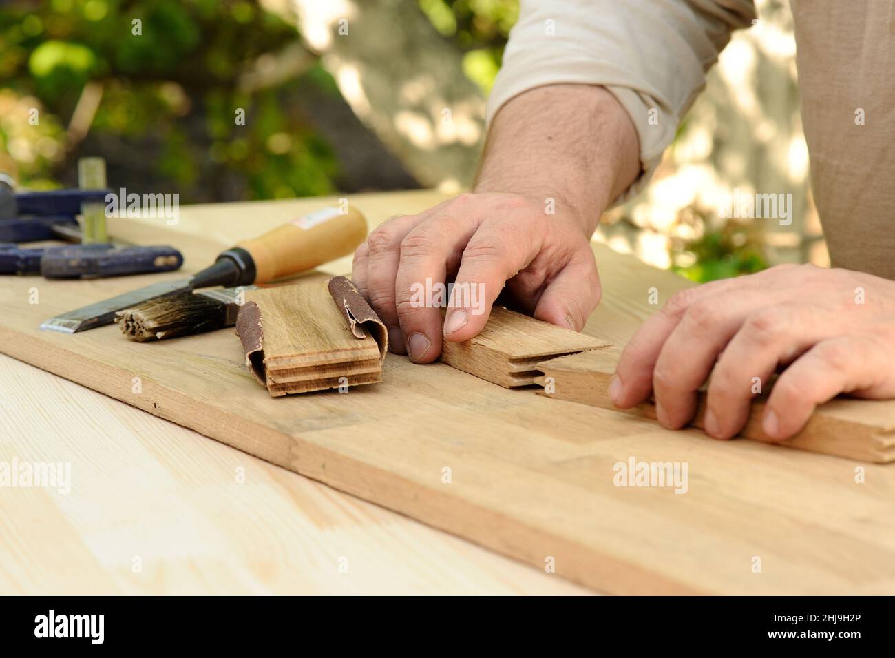 Carpenter hands at work with wooden boards horizontal Stock Photo - Alamy