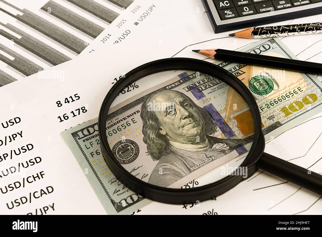 Dollars and money estimate through a magnifying glass close-up. Finance ...