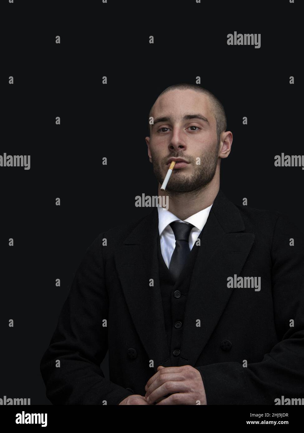 Elegant man who smokes, isolated on black background , Mafia face Stock ...