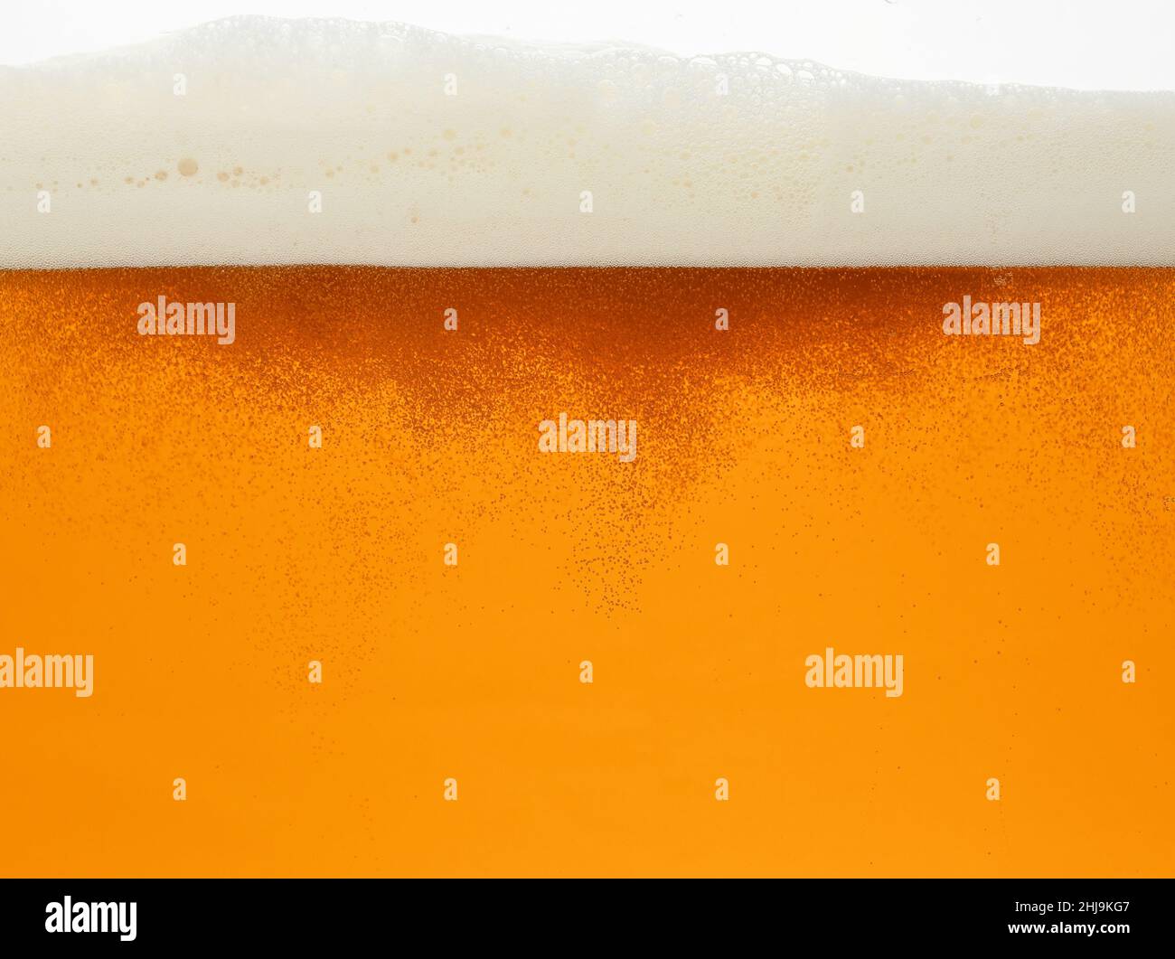 Close up background texture of lager beer with bubbles and froth ...