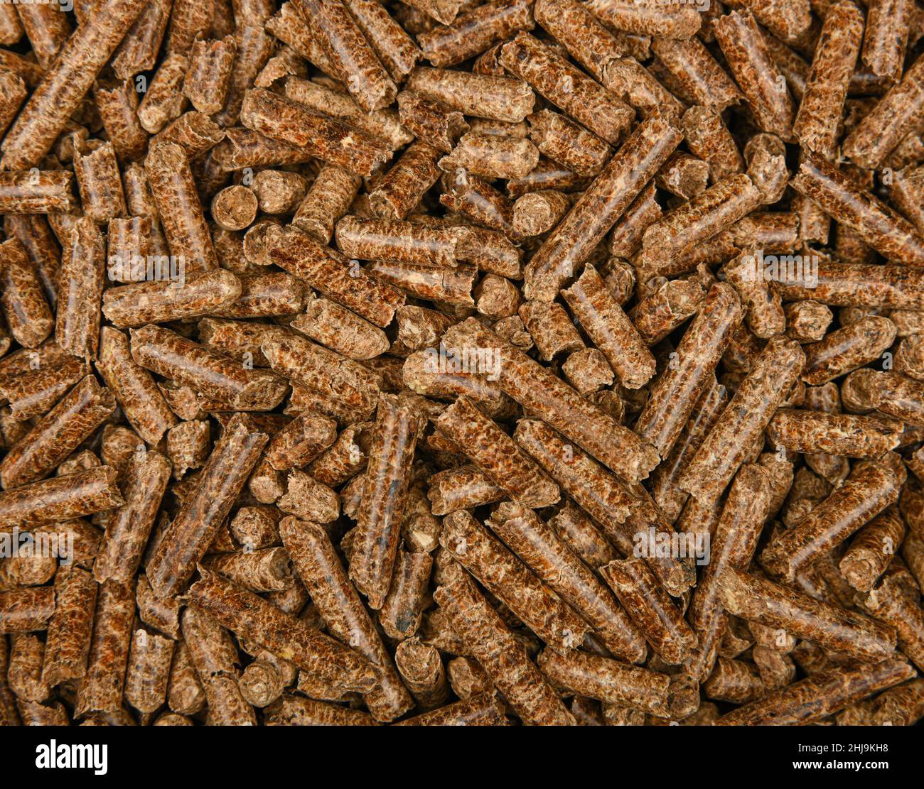 Close up background pattern of hardwood pellets for food smoking and ...