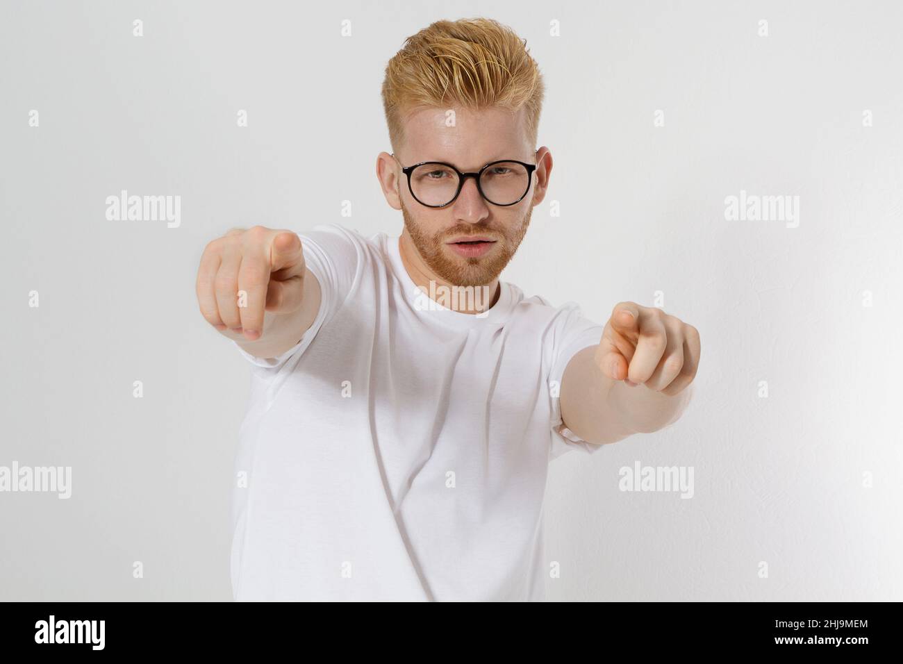 Guy pointing on you by fingers isolated on white background. Young ...