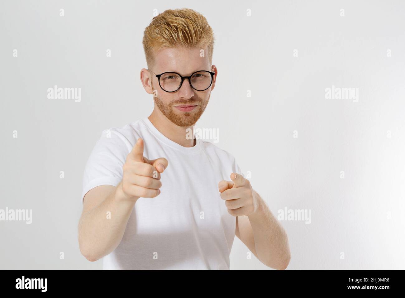 Guy pointing on you by fingers isolated on white background. Young ...