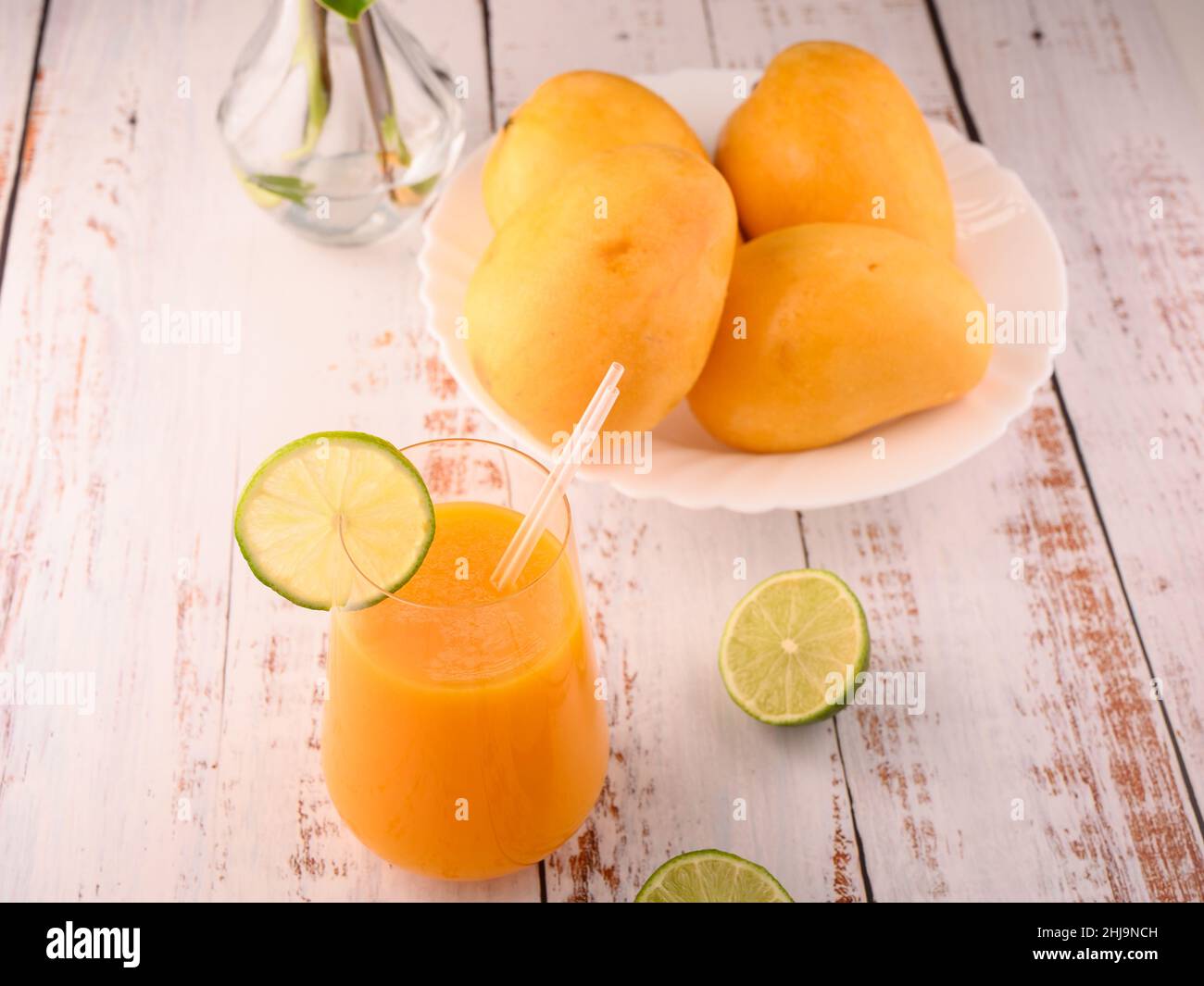 Photo shows glass transparent with natural mango liquor. In background ...