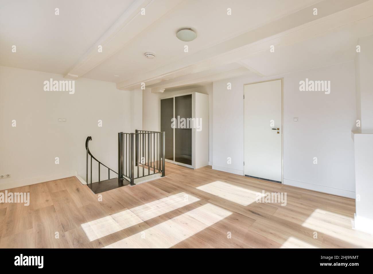 bright empty hall with a stylish closet and stairs access to the down ...