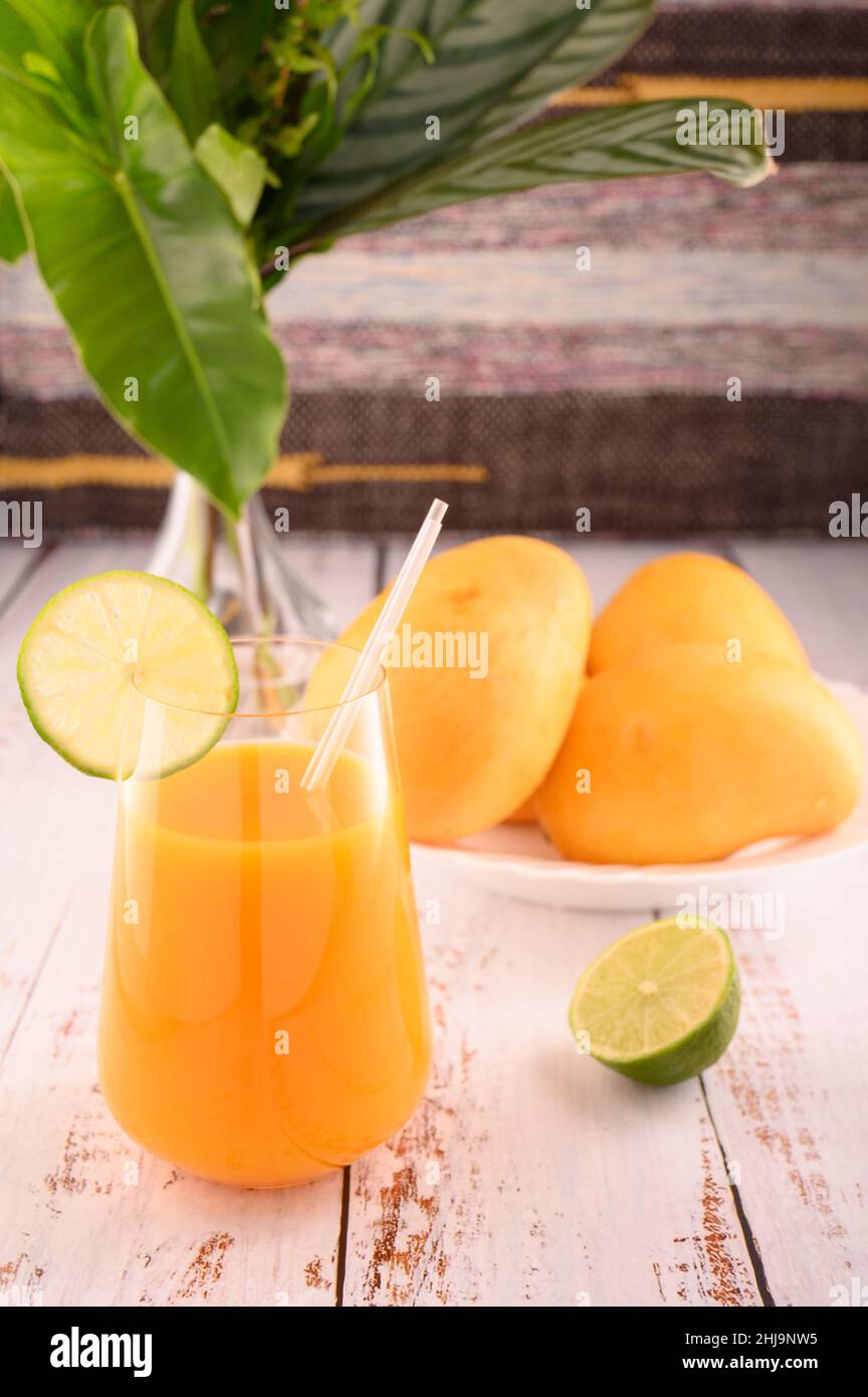 Photo shows glass transparent with natural mango martini. In background ...