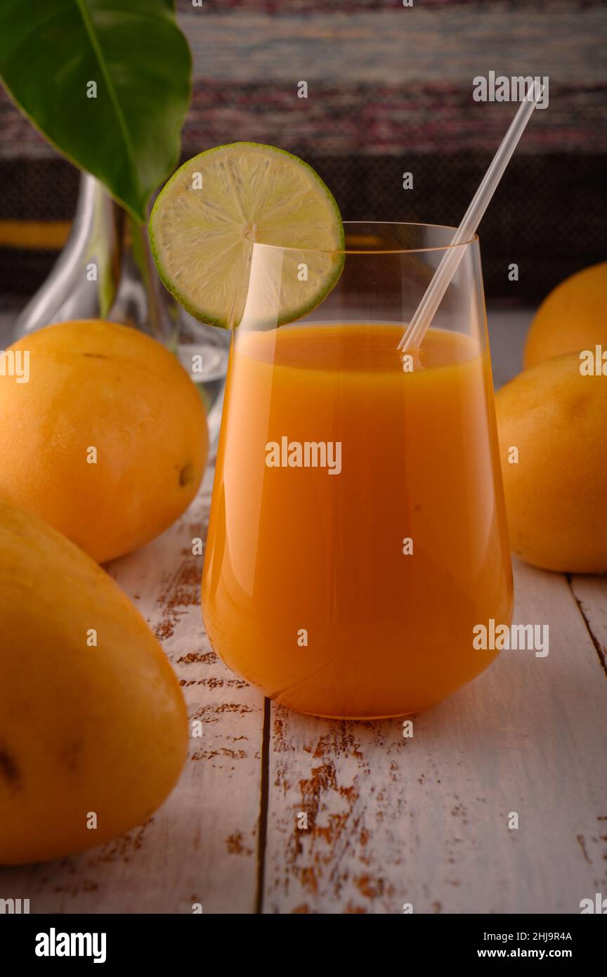 Photo shows glass transparent with natural fresh mango juice on vintage ...