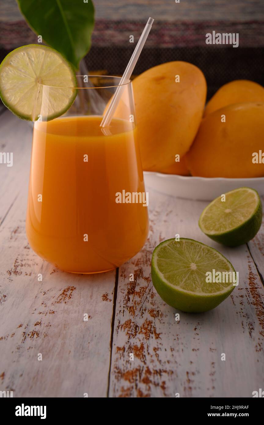 Photo shows glass transparent with natural fresh mango juice on vintage ...