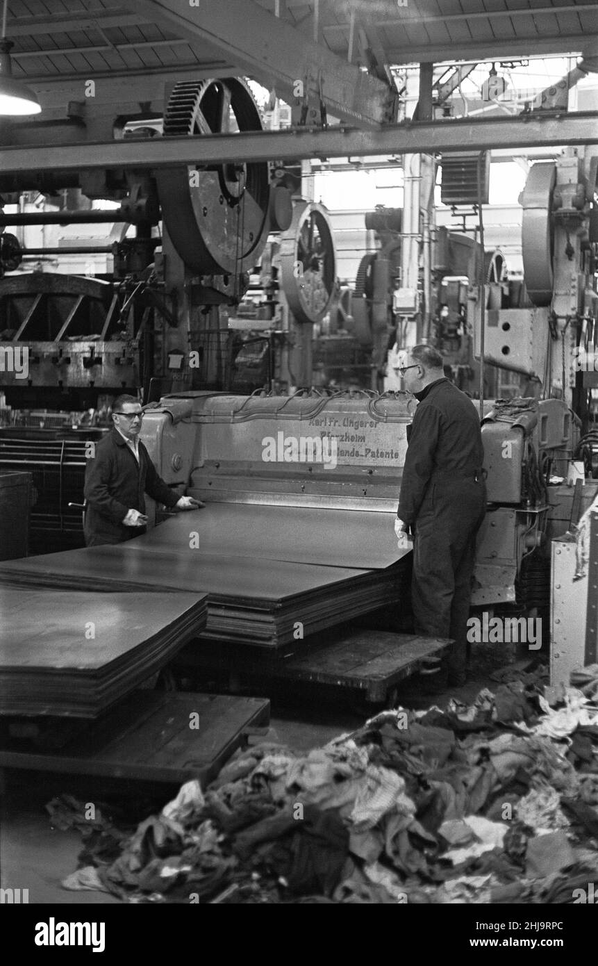 Metal sheets are fed into the body panel press at the The Austin Mini ...
