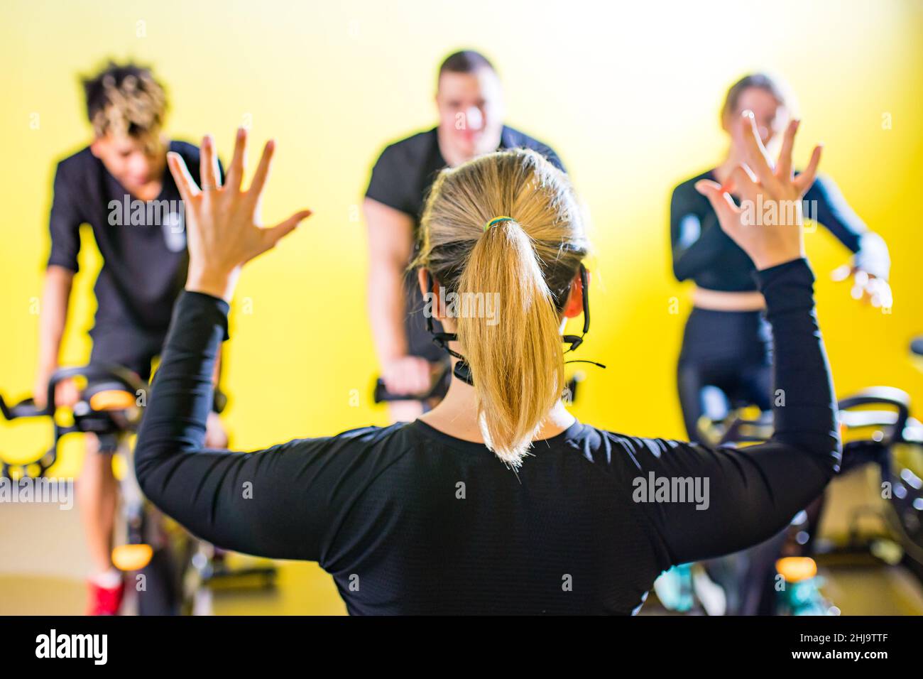 multicultural groyp of happy young strong people cycling In class while ...