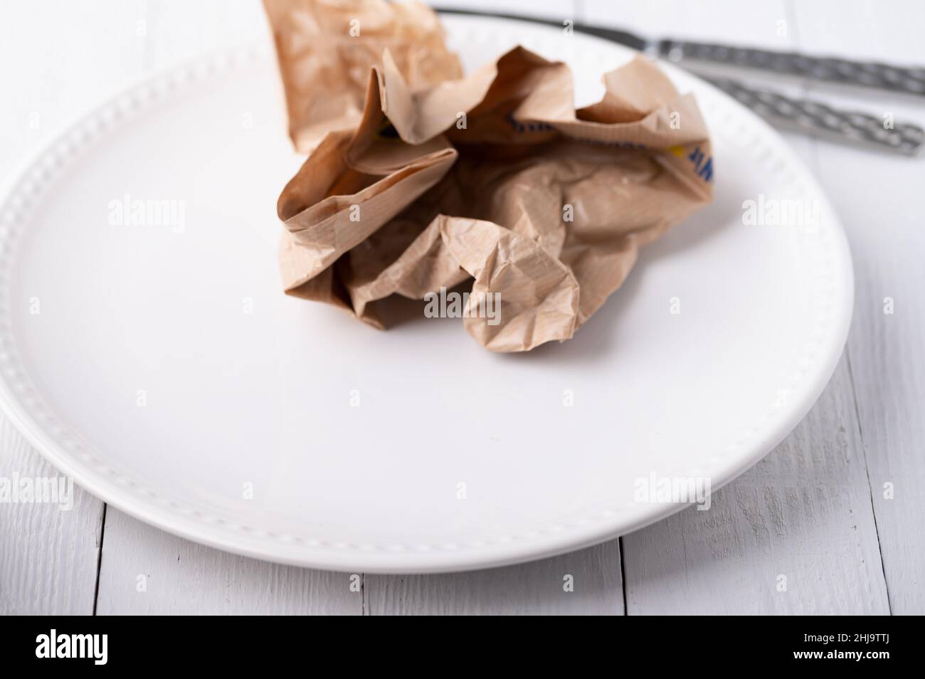 Closeup of an old Protecting Freight brown paper on a white ceramic ...