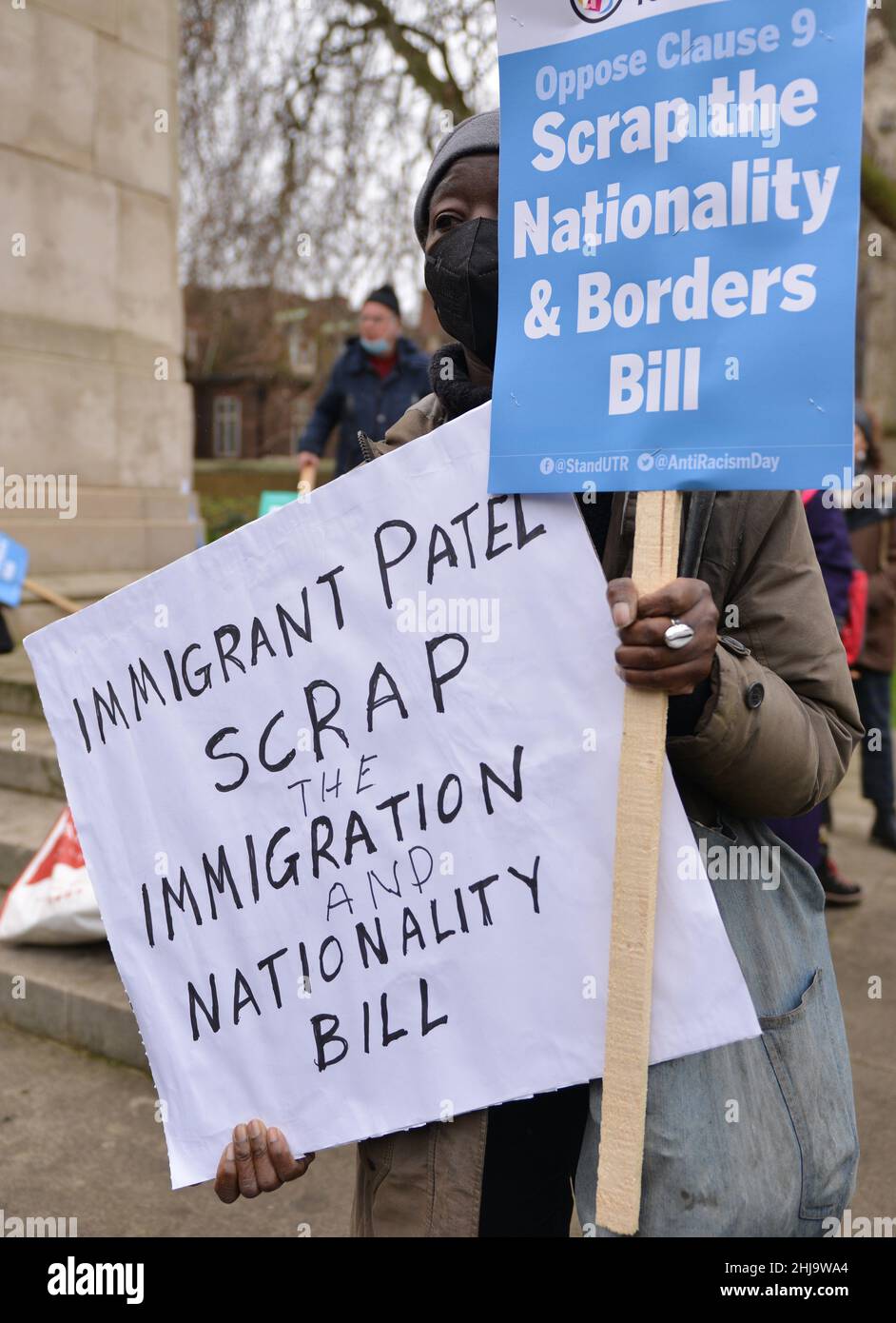 Demonstrator holds placards during the rally. Protesters gathered in ...