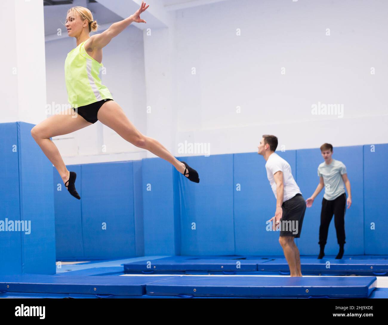 Female gymnast jumping on trampoline Stock Photo - Alamy