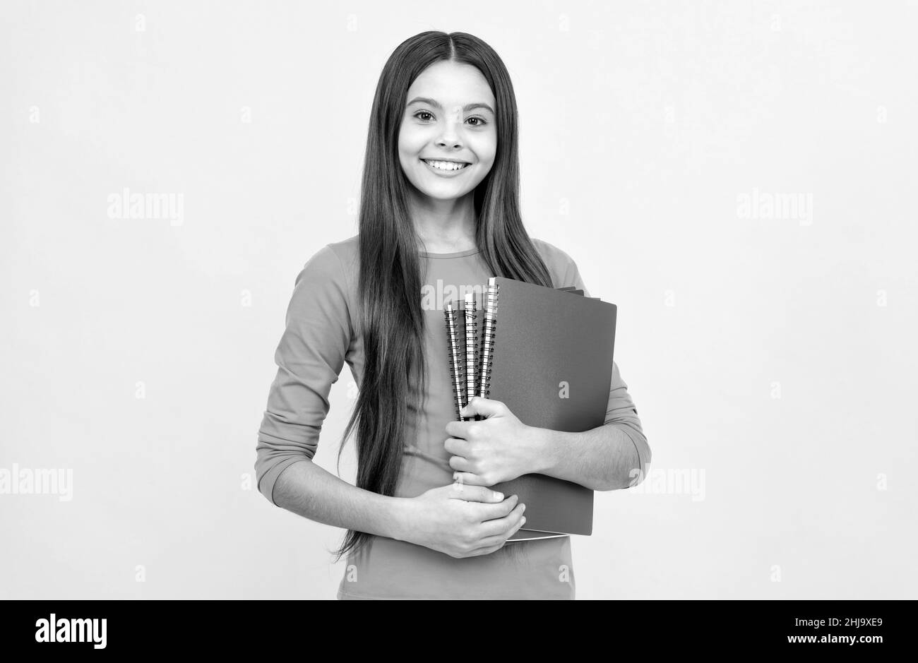 cheerful child girl hold notepad for homework, study Stock Photo - Alamy