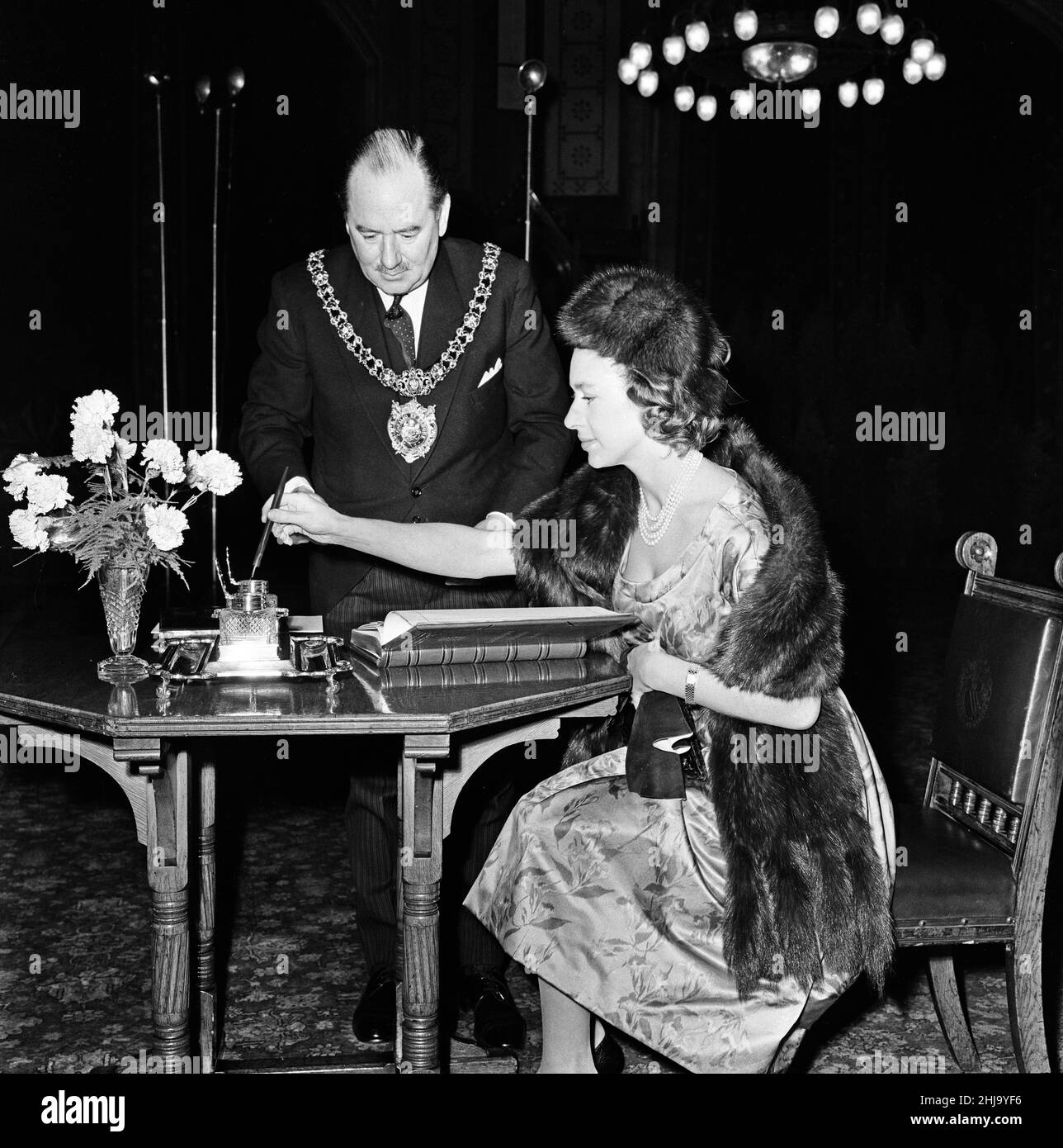 Princess Margaret visits Manchester. Margaret signs the visitors book ...