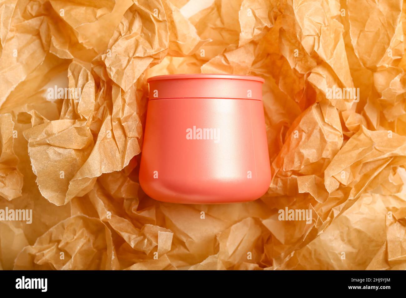 Cosmetic jar on craft paper background Stock Photo - Alamy