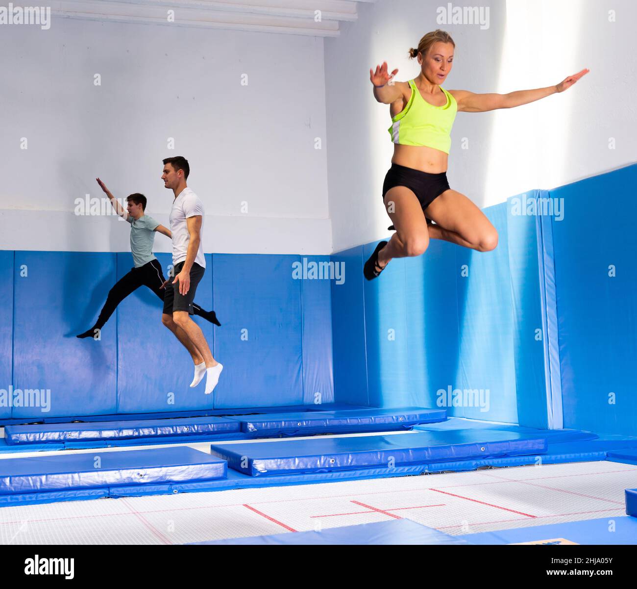 Female gymnast jumping on trampoline Stock Photo - Alamy